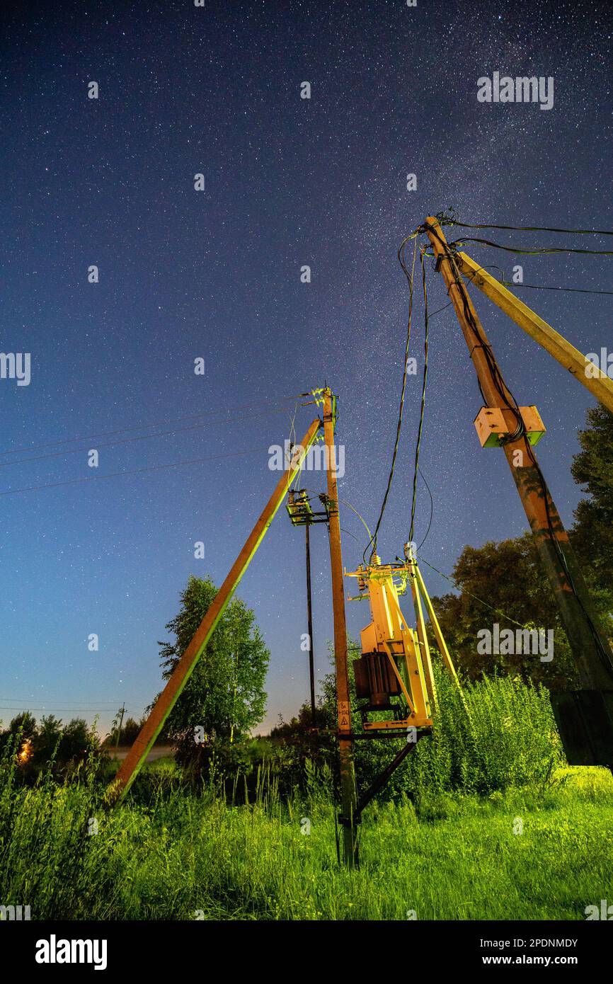 Electric transformer in forest. Night starry sky with glowing stars and ...
