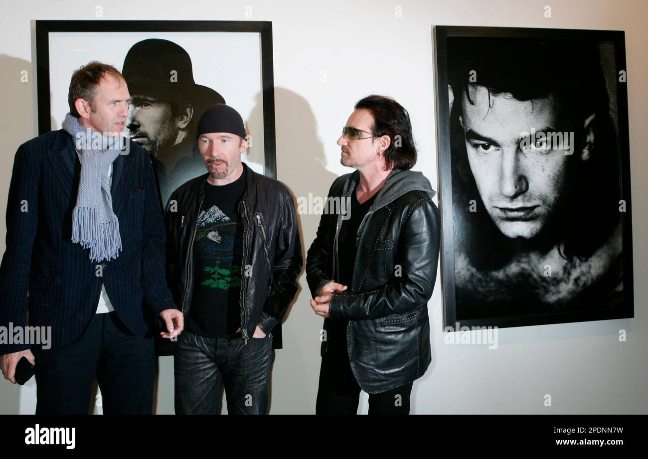 U2's Bono, right, and guitarist The Edge, center, talk with ...