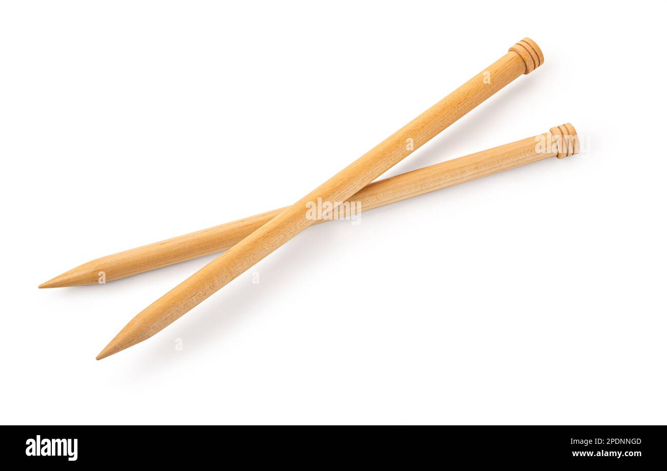 A pair of large wooden knitting needles from low perspective isolated ...