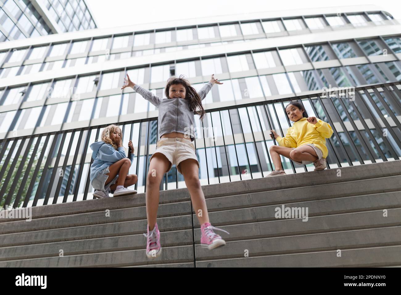 Two children jumping from hi-res stock photography and images - Alamy