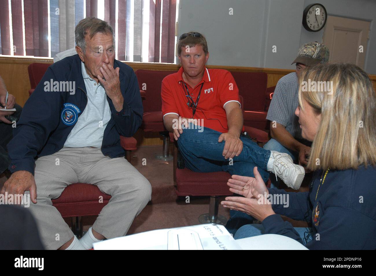 Former President George H.W. Bush, left, reacts to a progress report ...