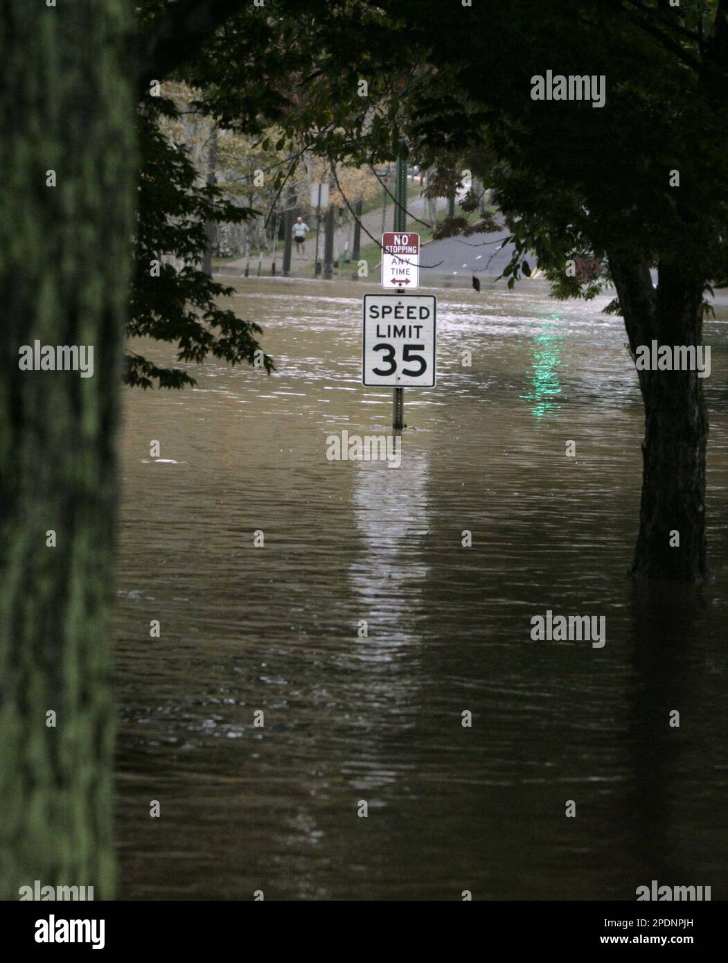 A traffic sign is submerged on a flooded section of Kelly Drive, which ...