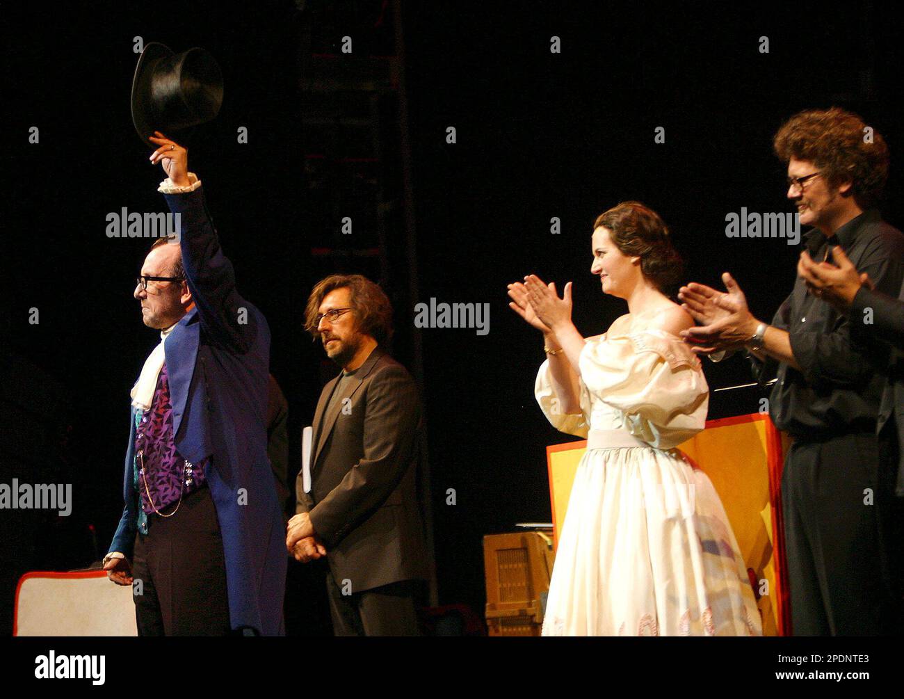 Musician Elvis Costello, left, acknowledges the raucous applause ...