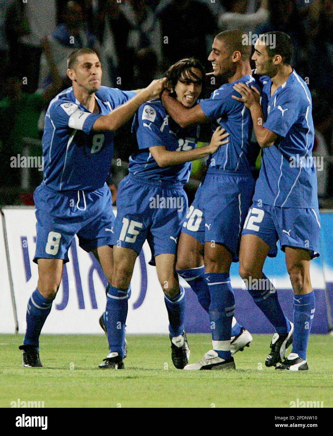 Israel's Yossi Benayoun, second left, is congratulated by teammates ...