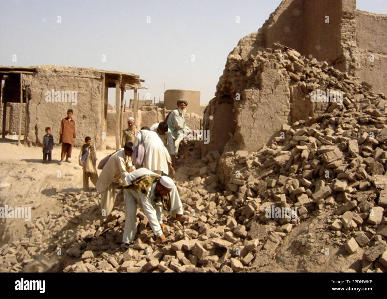 Afghans search among the debris of a house destroyed by an earthquake ...