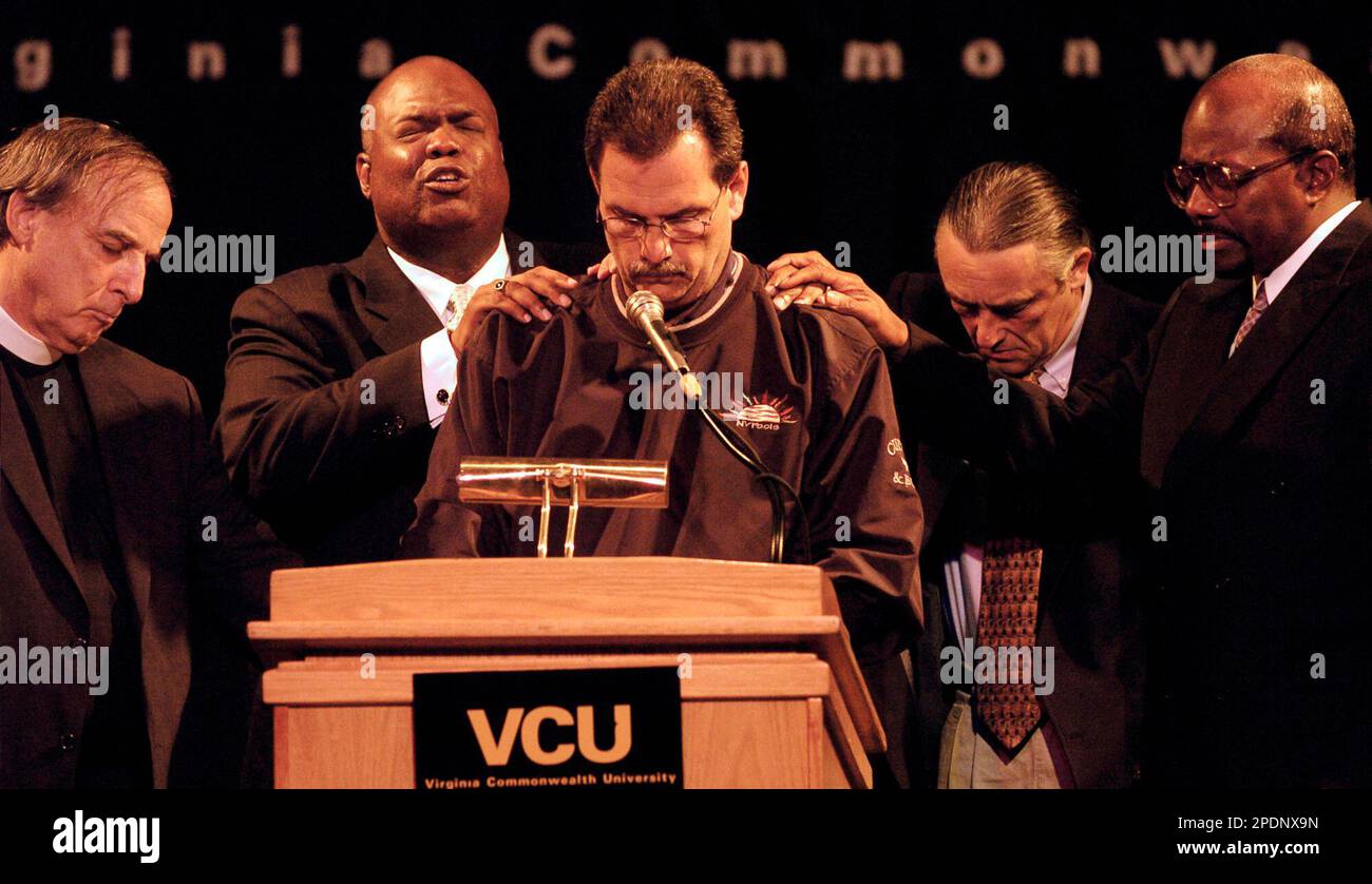 Matt Behl, center, of Vienna, Va., is comforted by clergymen during a ...