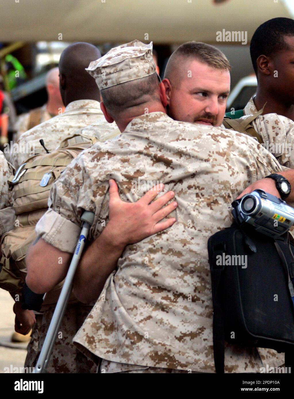 Sgt. Daniel Kozar, right, hugs Staff Sgt. Daniel Priestly as the Brook ...