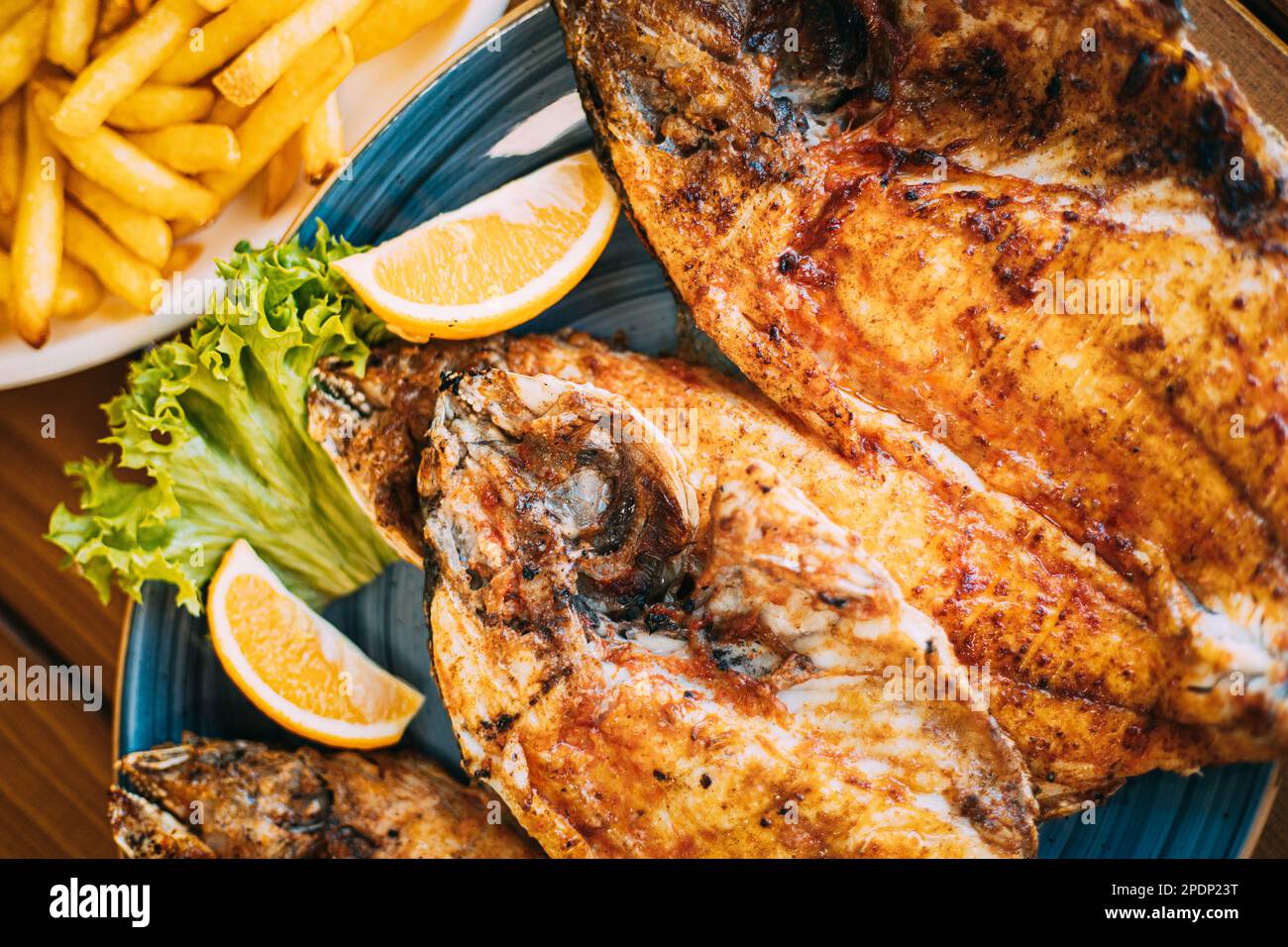 Dish with Gilt-head bream Fish With orange and french fries. Dorada ...