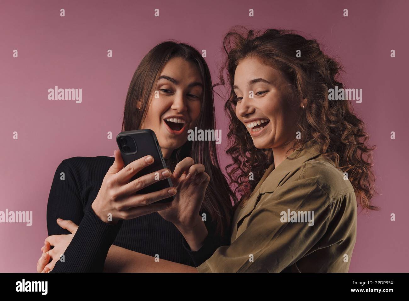 Portrait of two young happy girls, studio shoot Stock Photo - Alamy