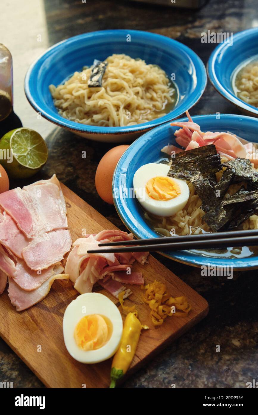 ramen soup in plates ingredients on the table Stock Photo - Alamy