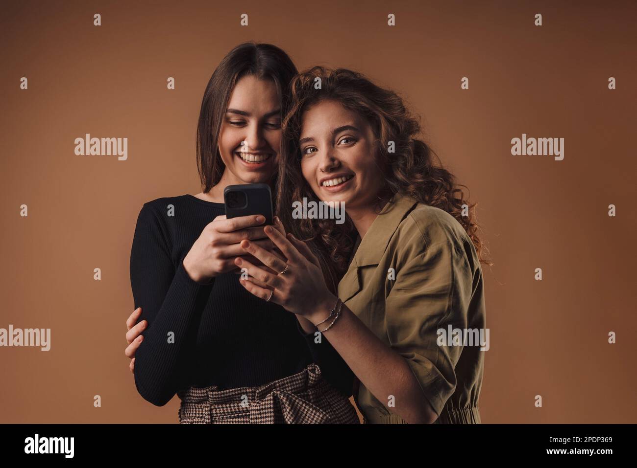 Portrait of two young happy girls, studio shoot Stock Photo - Alamy