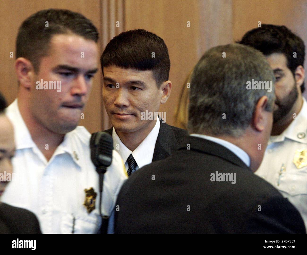 Siny Van Tran, center, is escorted into Suffolk Superior in Boston ...