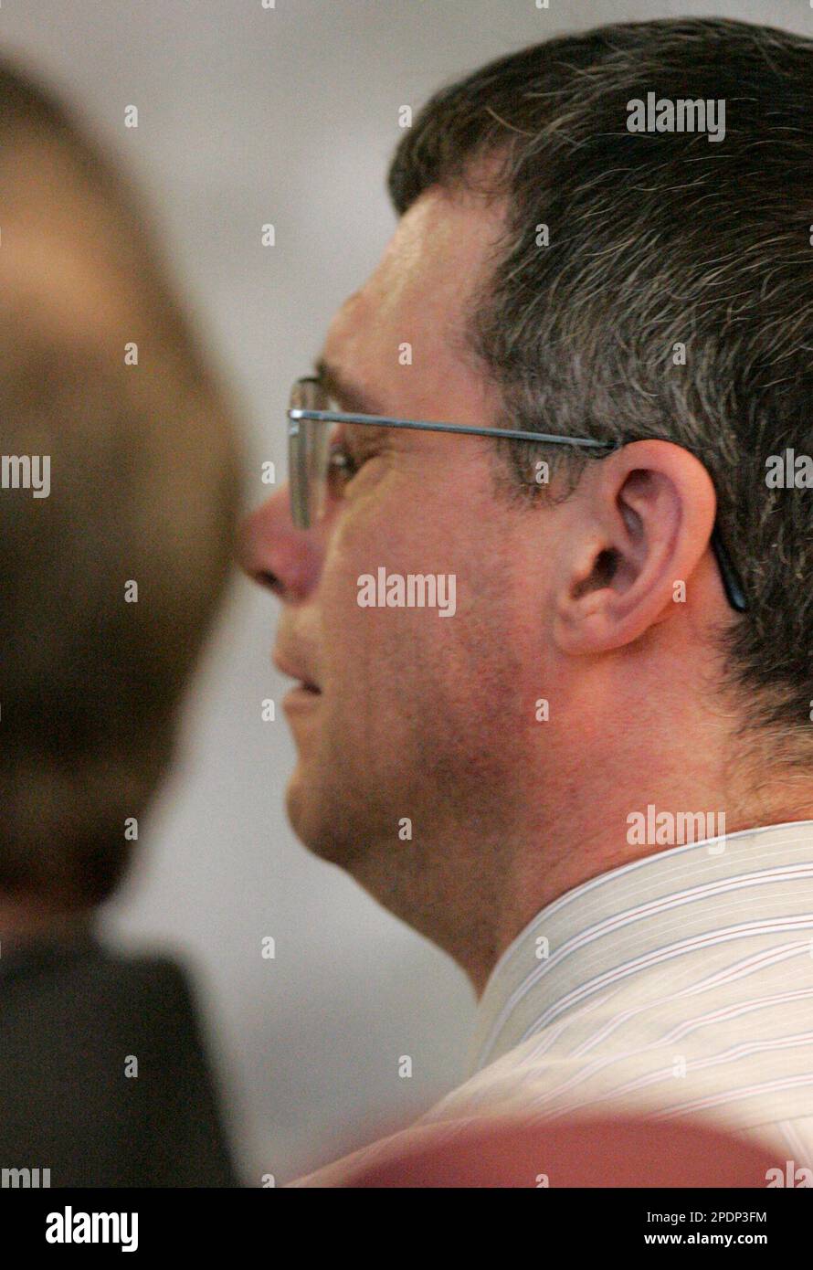 Defendant James E. Trimble reacts as graphic photos are displayed in ...