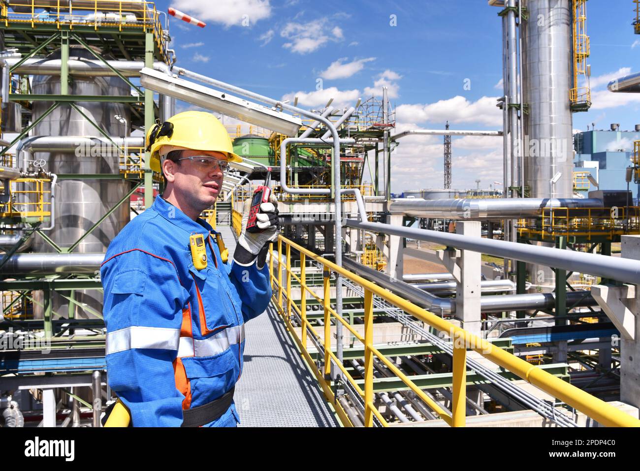 chemical industry plant - workers in work clothes in a refinery with ...
