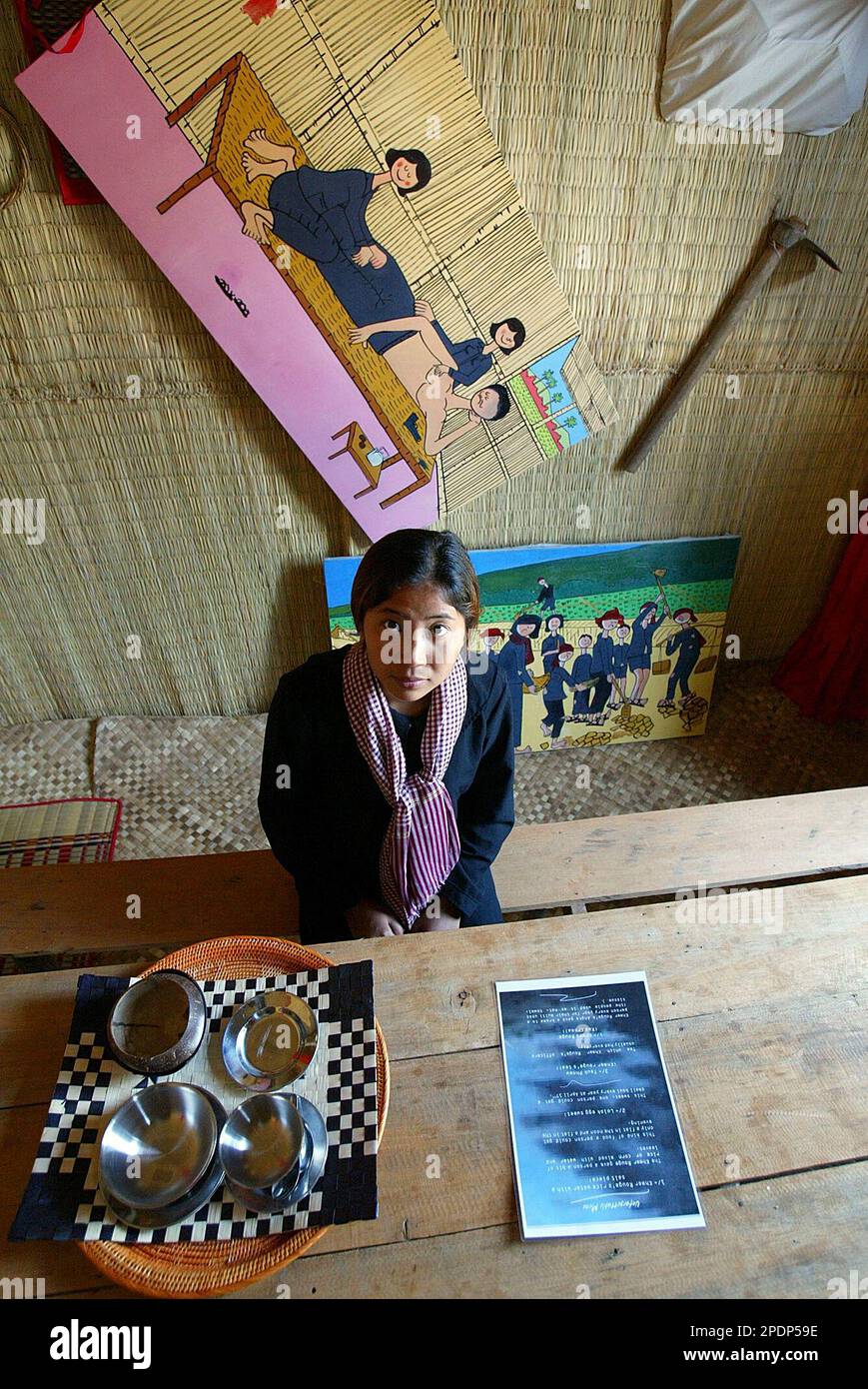 Dara Chan, Cambodian waitress at the "Cafe History - Khmer Rouge Experience" restaurant, wears ...