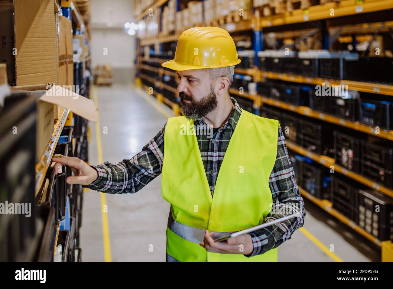 Warehouse worker checking up stuff in a warehouse Stock Photo - Alamy