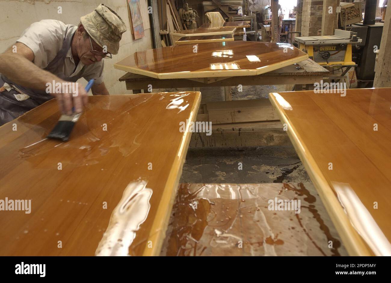 James "Tom Kitty" Mills pulls a speck of dust from the polymer coating ...