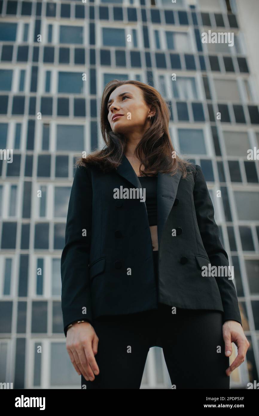 Fashion street style portrait of a beautiful girl in a black suit. A ...