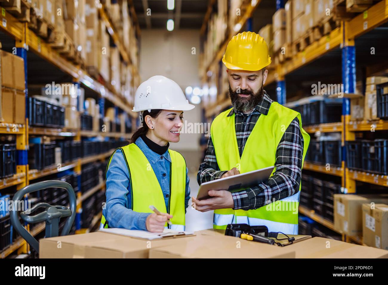 Warehouse workers checking stuff in warehouse with digital system in ...