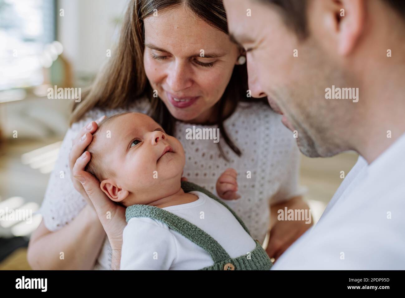 Happy parents cuddling with their newborn baby Stock Photo - Alamy