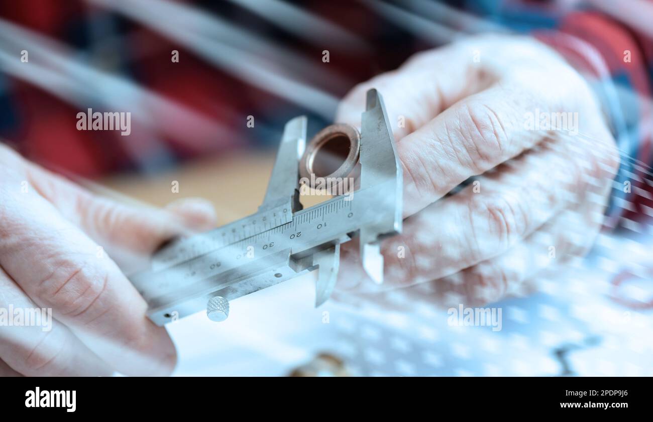 Plumber measuring a copper tube with a caliper; light effect Stock ...