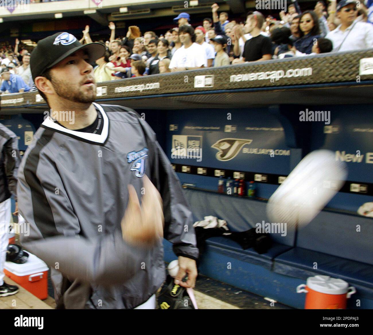 Toronto Blue Jays pitcher Shaun Marcum tosses a ball to fans after the ...