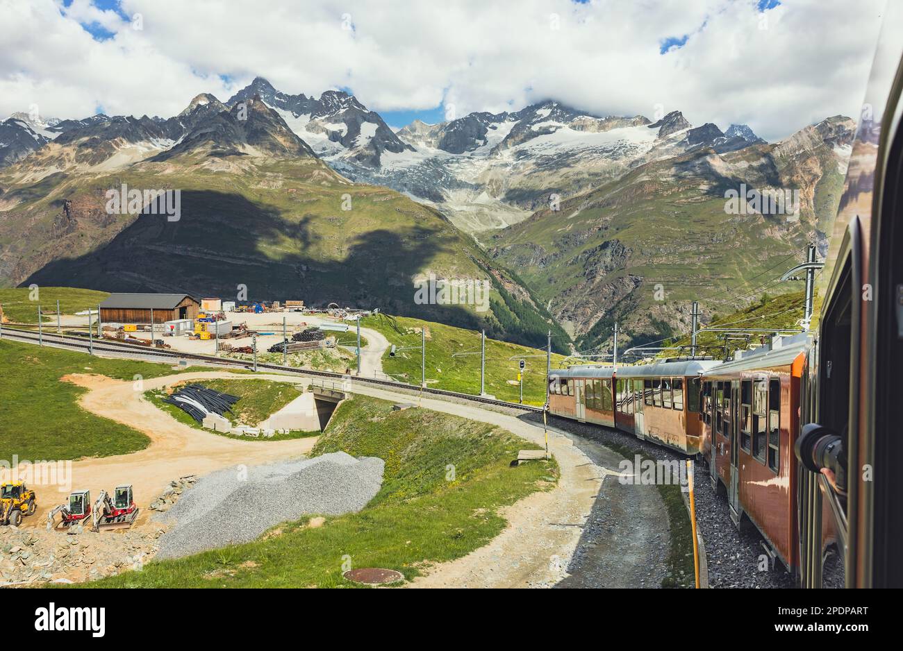 red train on the background of the Matterhorn mountain in the Swiss ...
