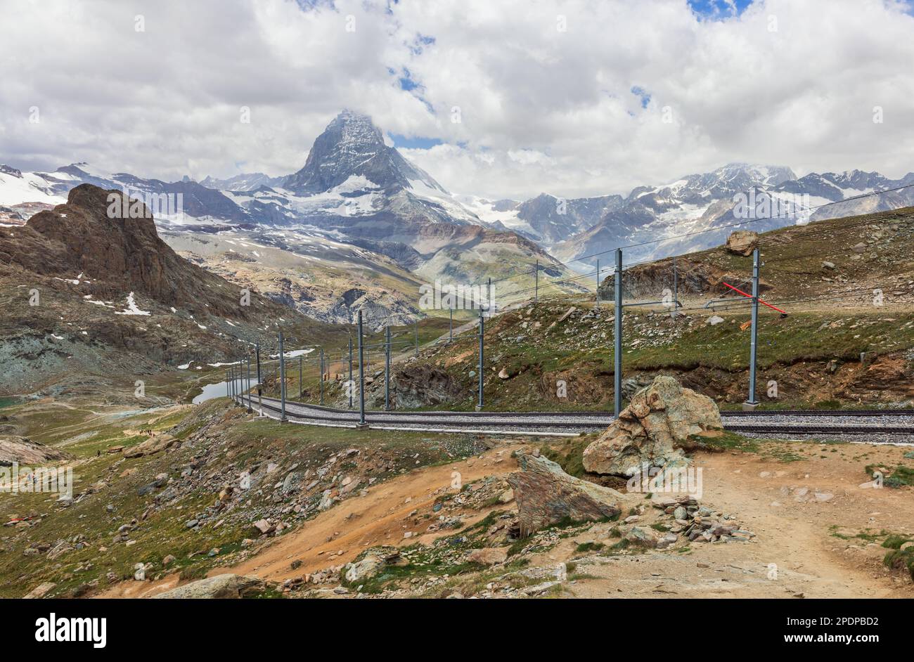 red train on the background of the Matterhorn mountain in the Swiss ...