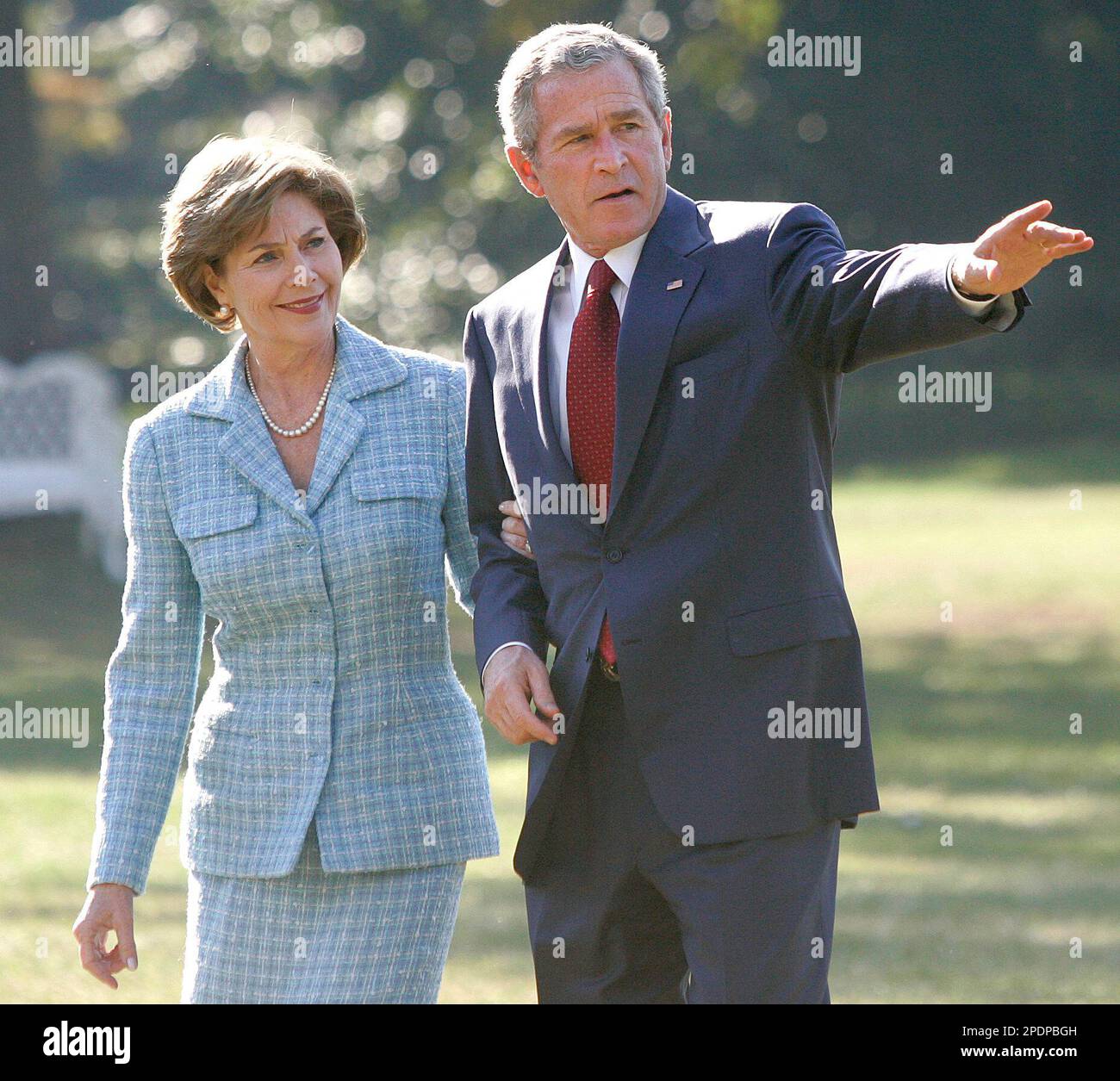 President Bush and his wife, Laura, arrive at the White House after a ...