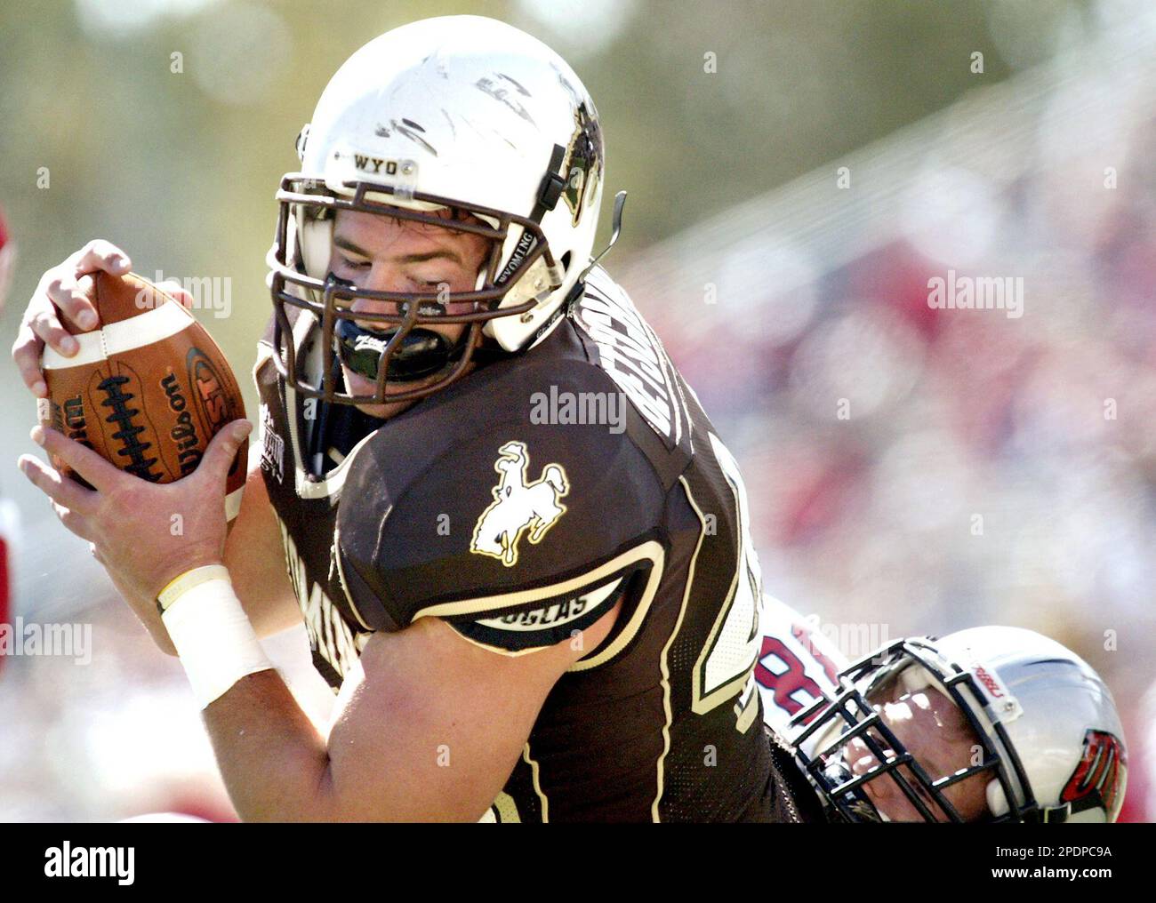 Wyoming tight end Wade Betschart, left, is tackled in the end zone by ...