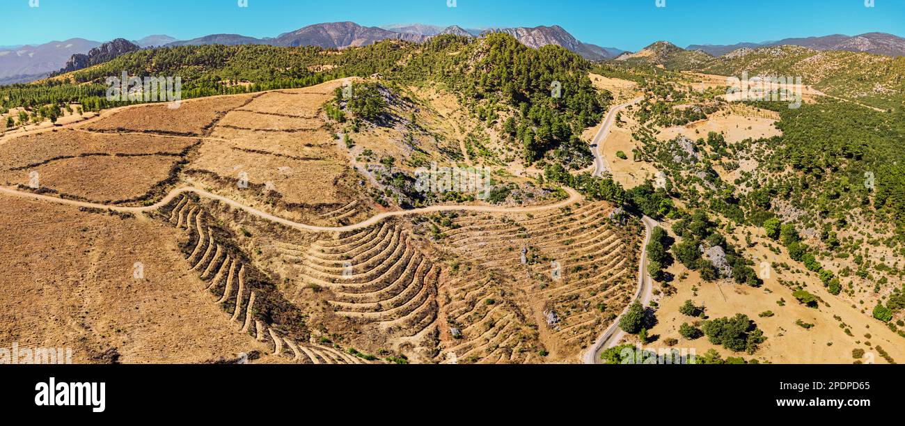 Aerial view of hillside road and mountain terraces, agriculture in arid ...
