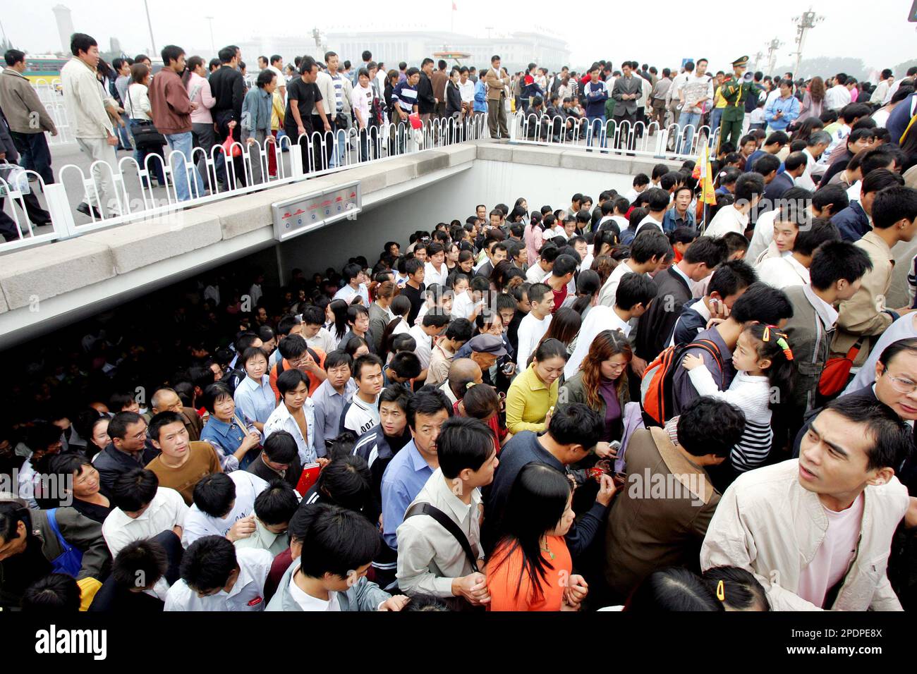 A crowd emerges from an underpass below Beijing's Tiananmen Square on ...
