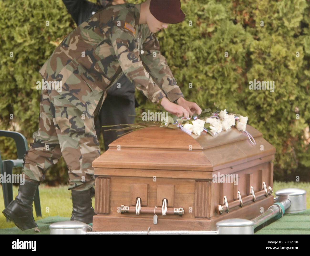 Pvt. 1st Class Lawrence Morrison II lays his father's dogtags on his ...
