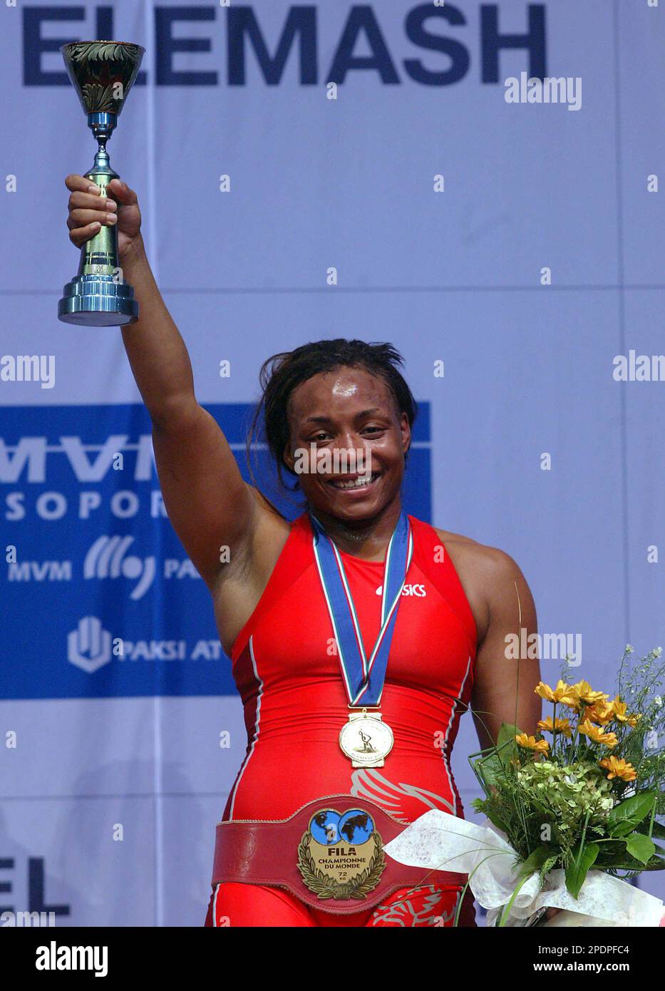 Iris Smith of the U.S. lifts her trophy on the podium following the ...