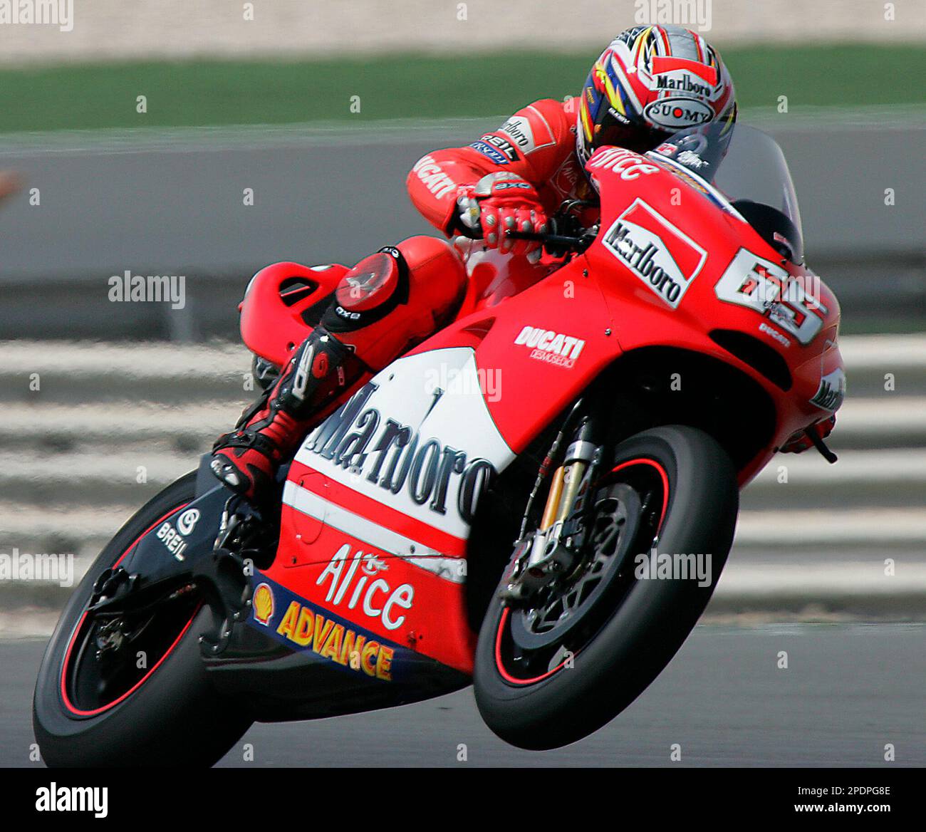 MotoGP rider, Italy's Loris Capriossi speeds along on his back wheel ...