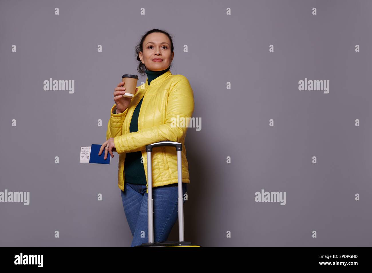 Attractive woman passenger, holding takeaway coffee in disposable cup ...