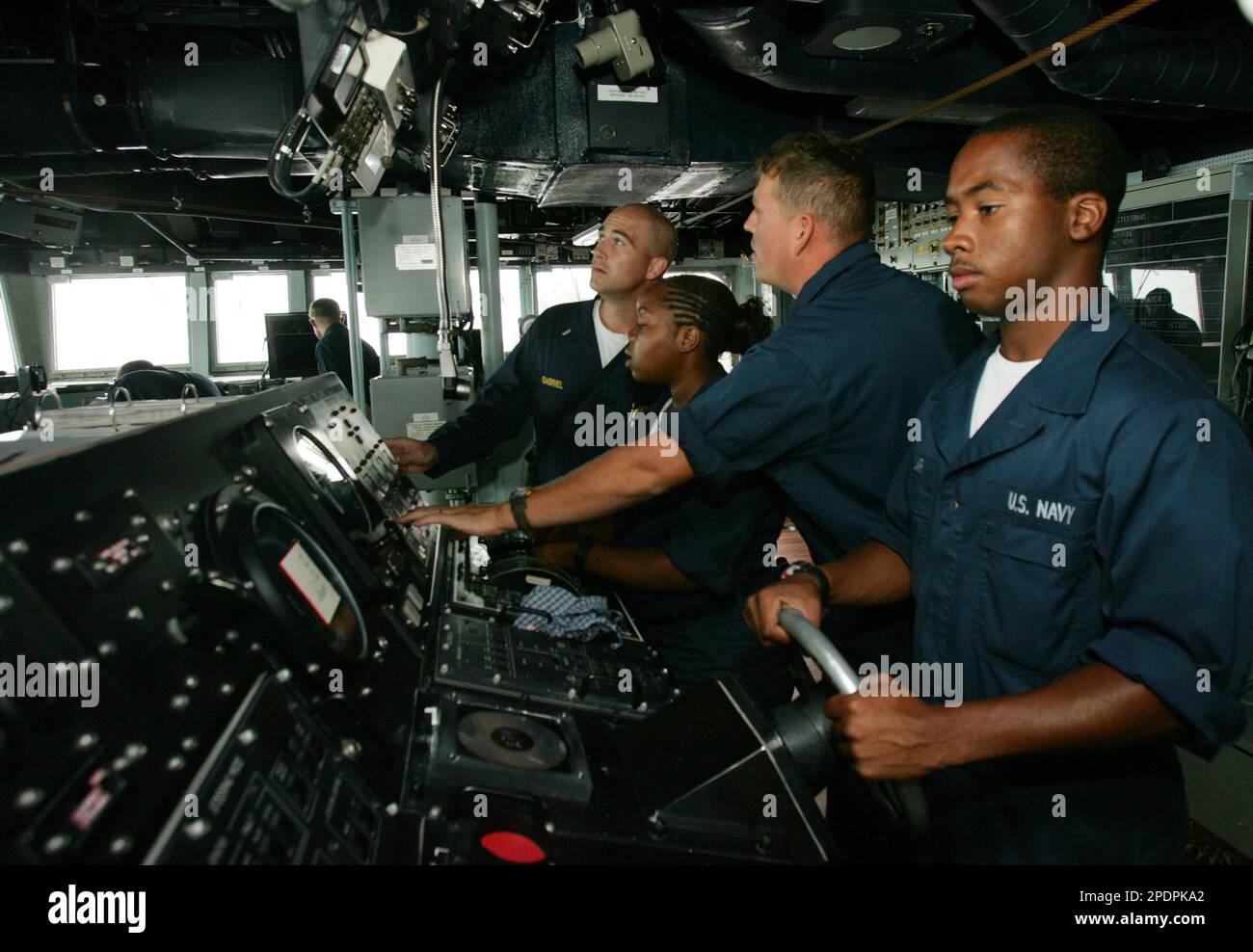 U.S. Navy officers maneuver the U.S. Navy missile guided ship USS ...