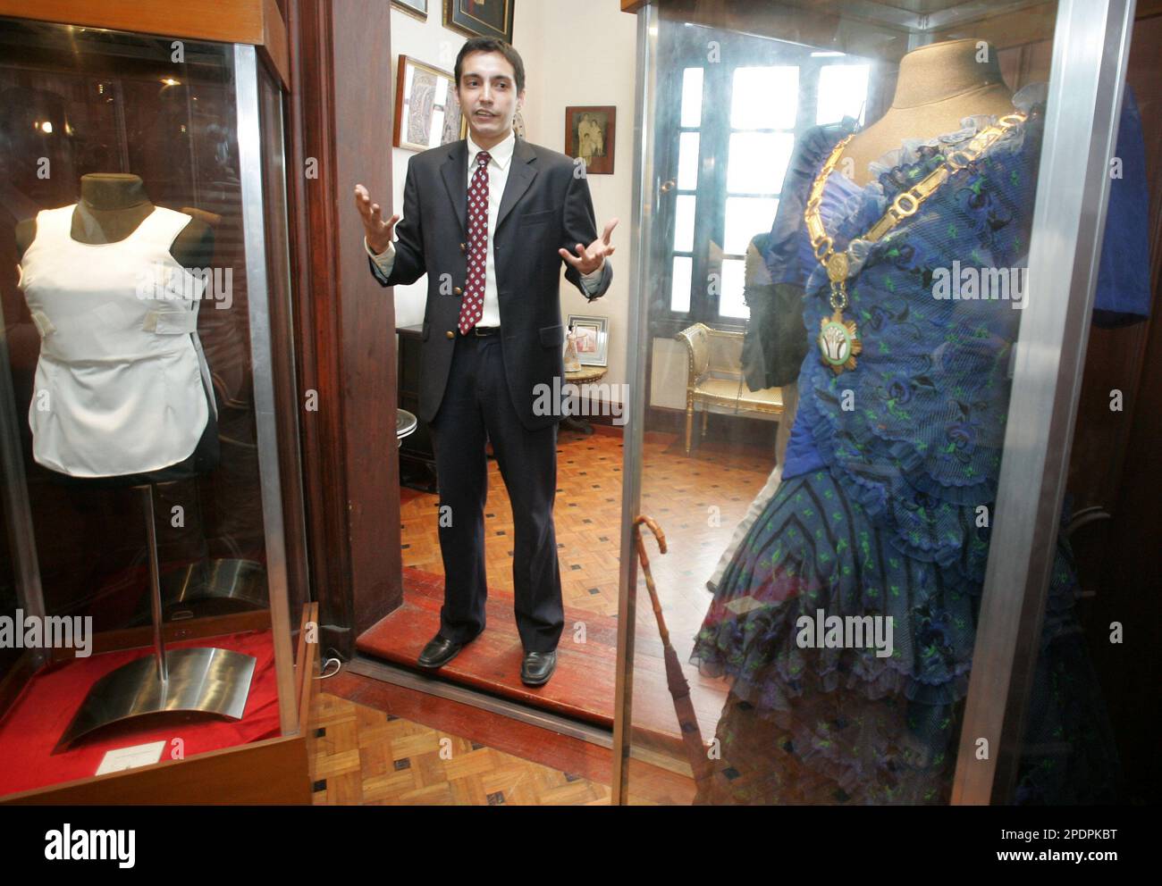 Museum Director Jeremy Barns shows a gown, right, and bulletproof vest ...