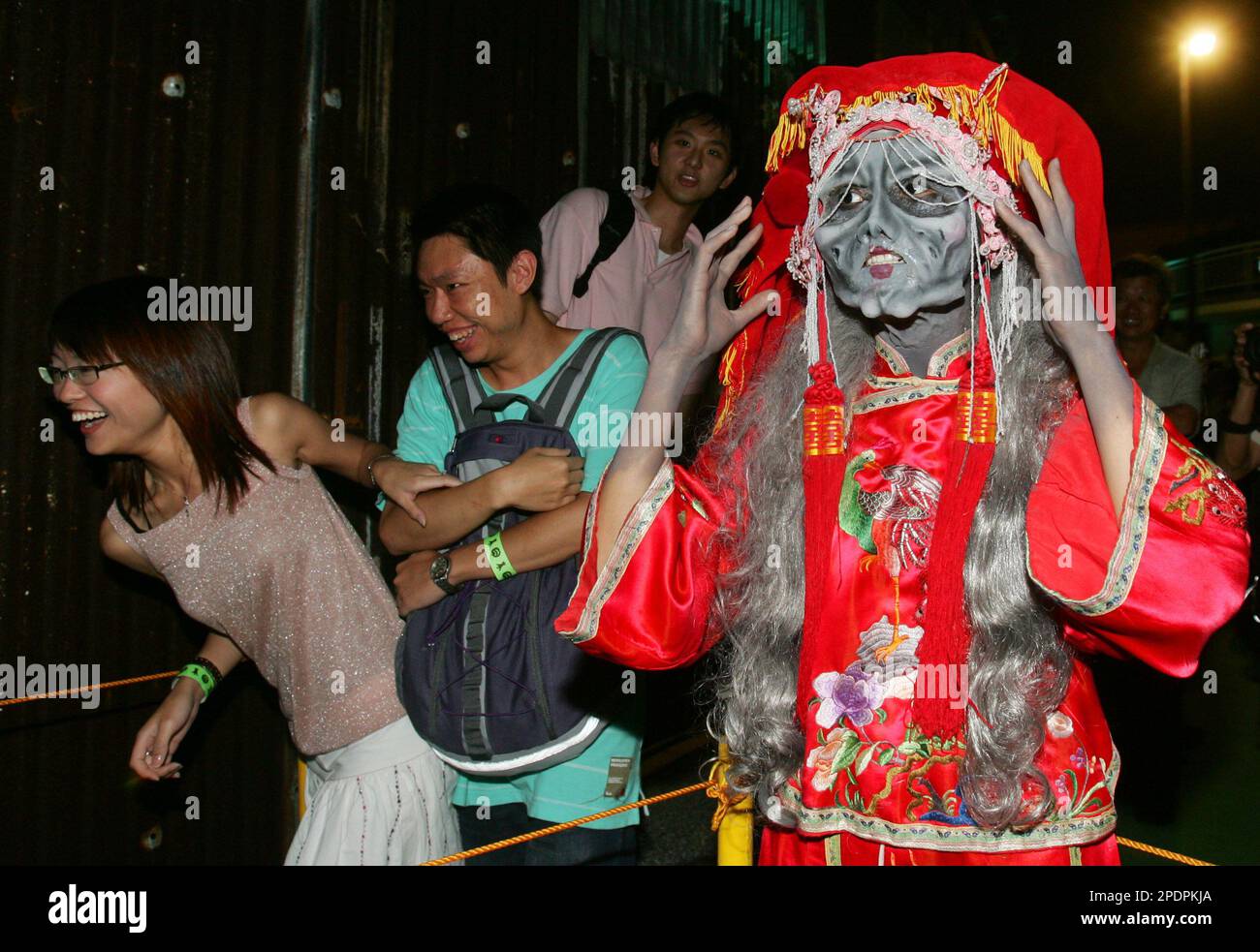 An actress, dressed as a Chinese ghost bride, tries to frighten the ...