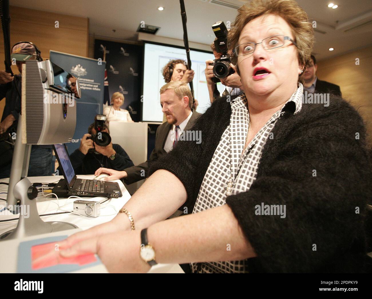 Senator Amanda Vanstone right pulls a funny face as she places her hand ...