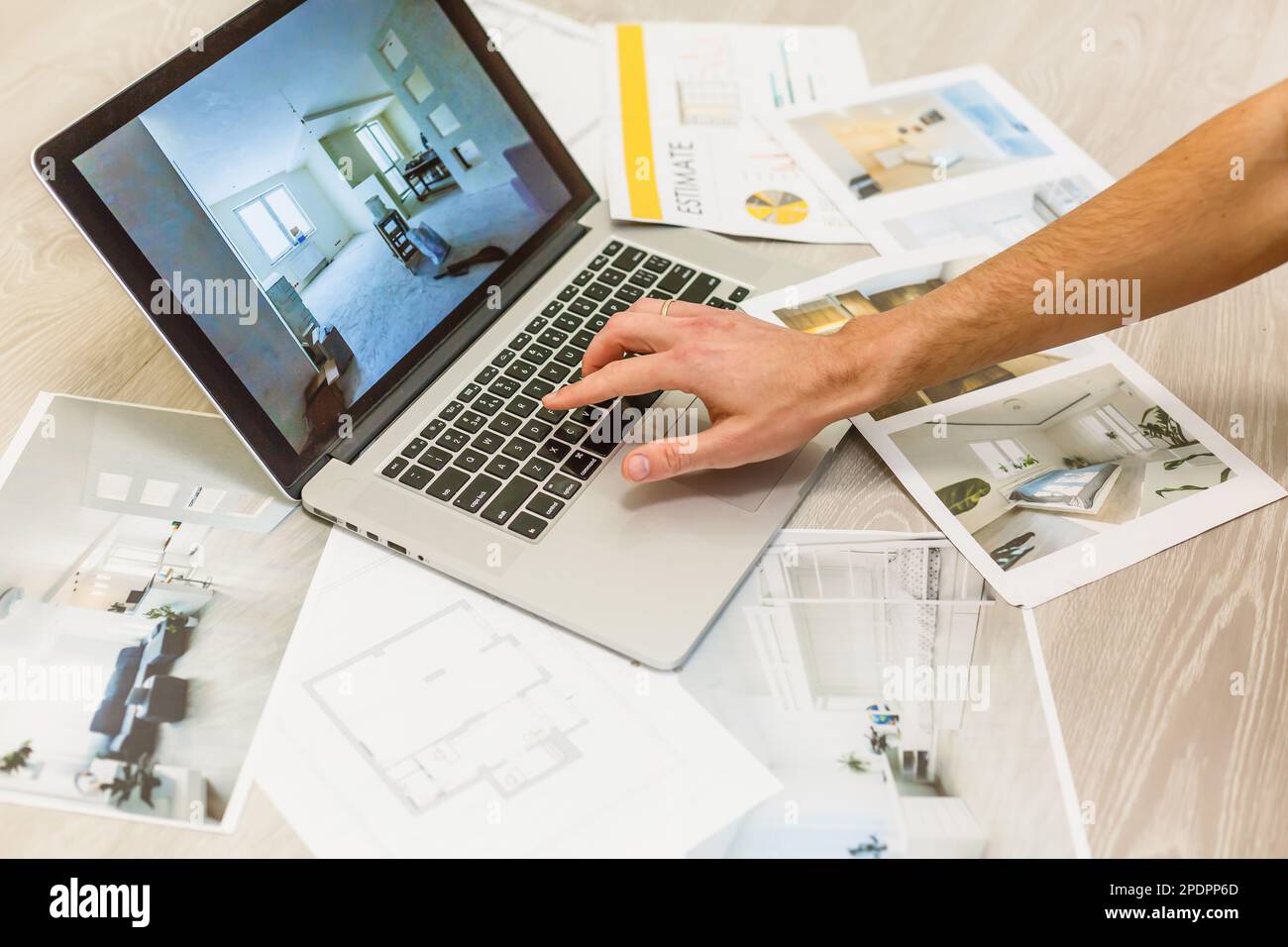 Decorator's hands with ruler on project drawings. Laptop, color ...