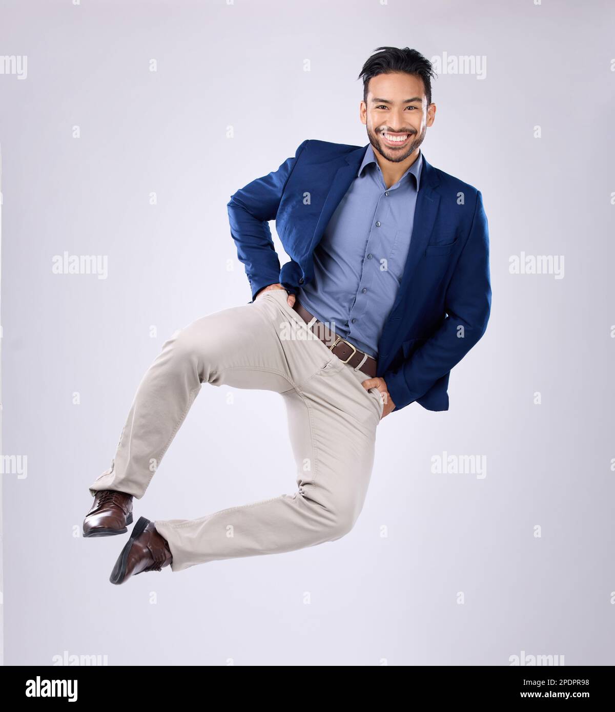 Happy, freedom and portrait of an Asian man jumping isolated on a white ...
