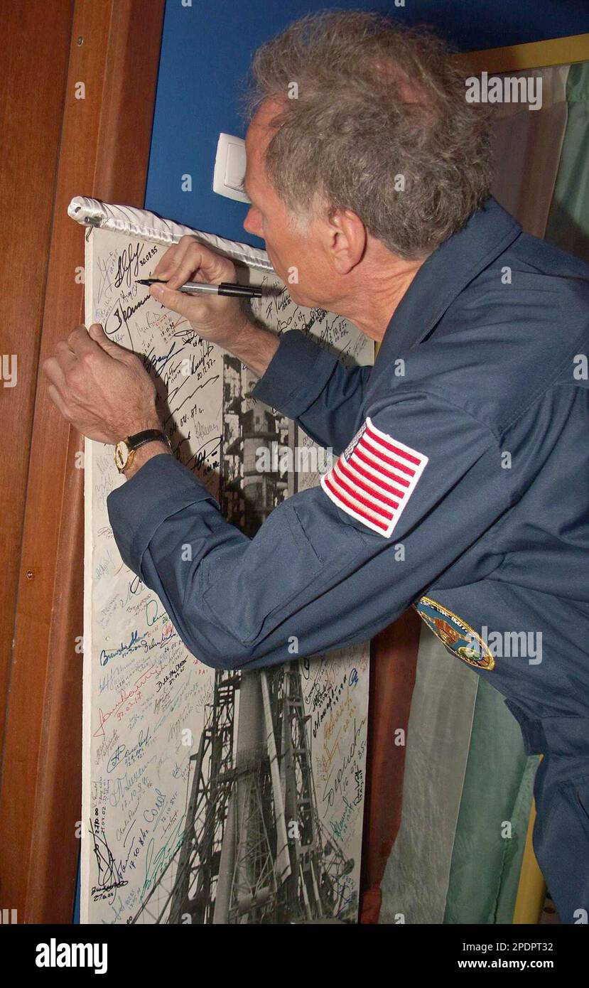 New space tourist Gregory Olsen of the United States, signs the ...