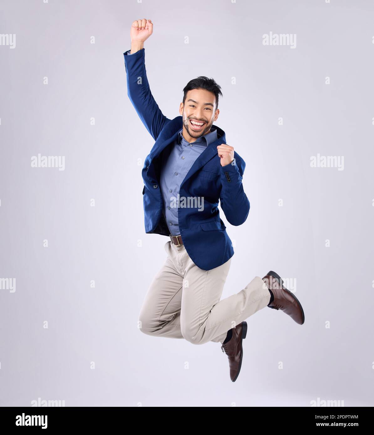 Success, excited and portrait of an Asian man jumping isolated on a ...