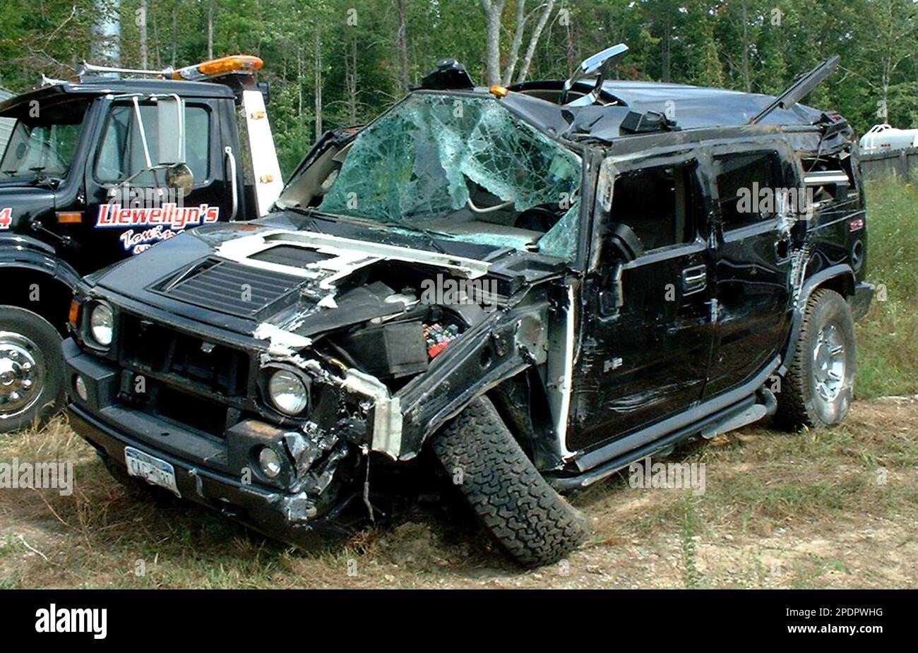 A wrecked Hummer sport utility vehicle sits in a salvage yard in ...