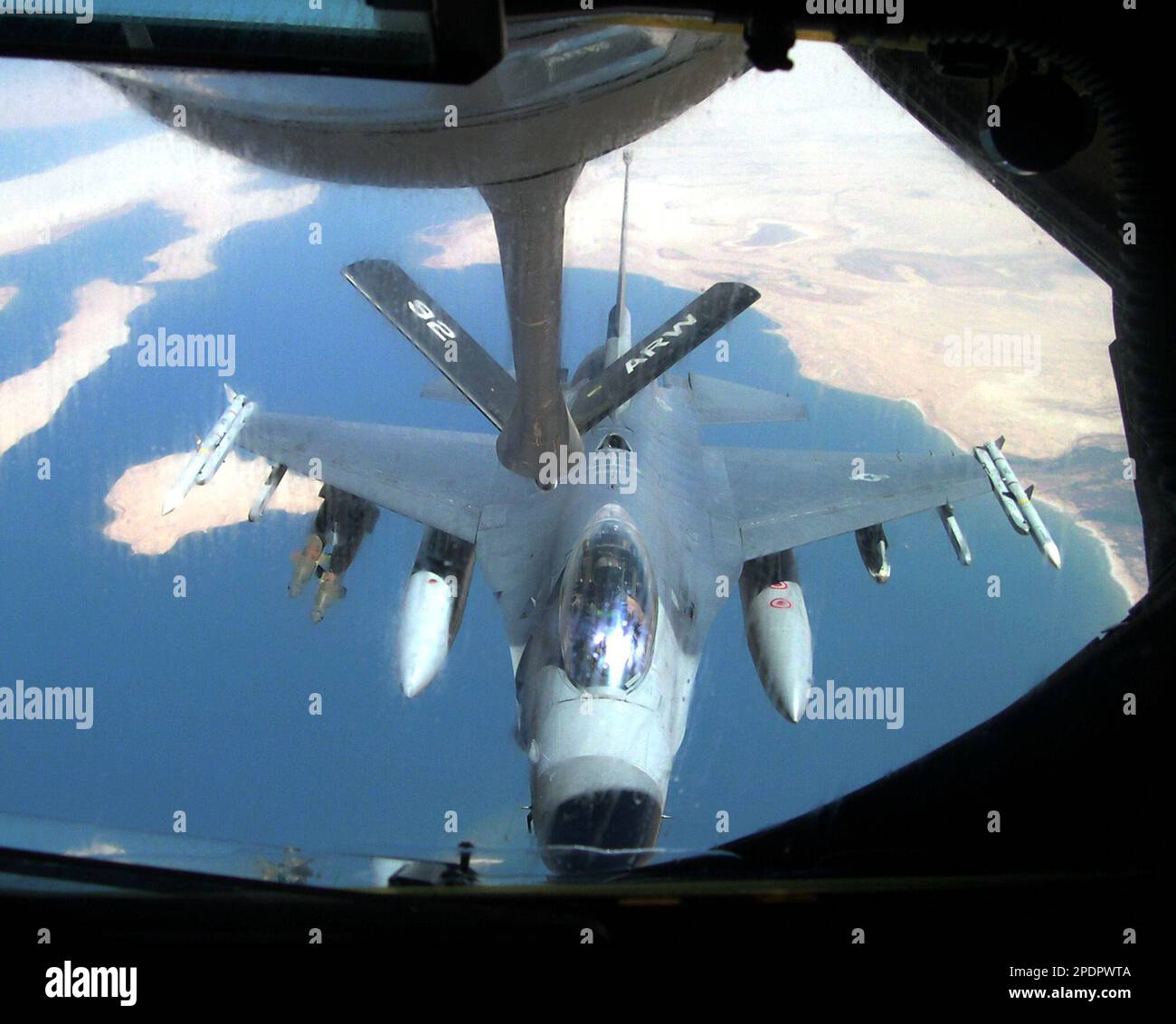 Air Force F-16s approaches a KC-135 air refueling tanker to refuel ...