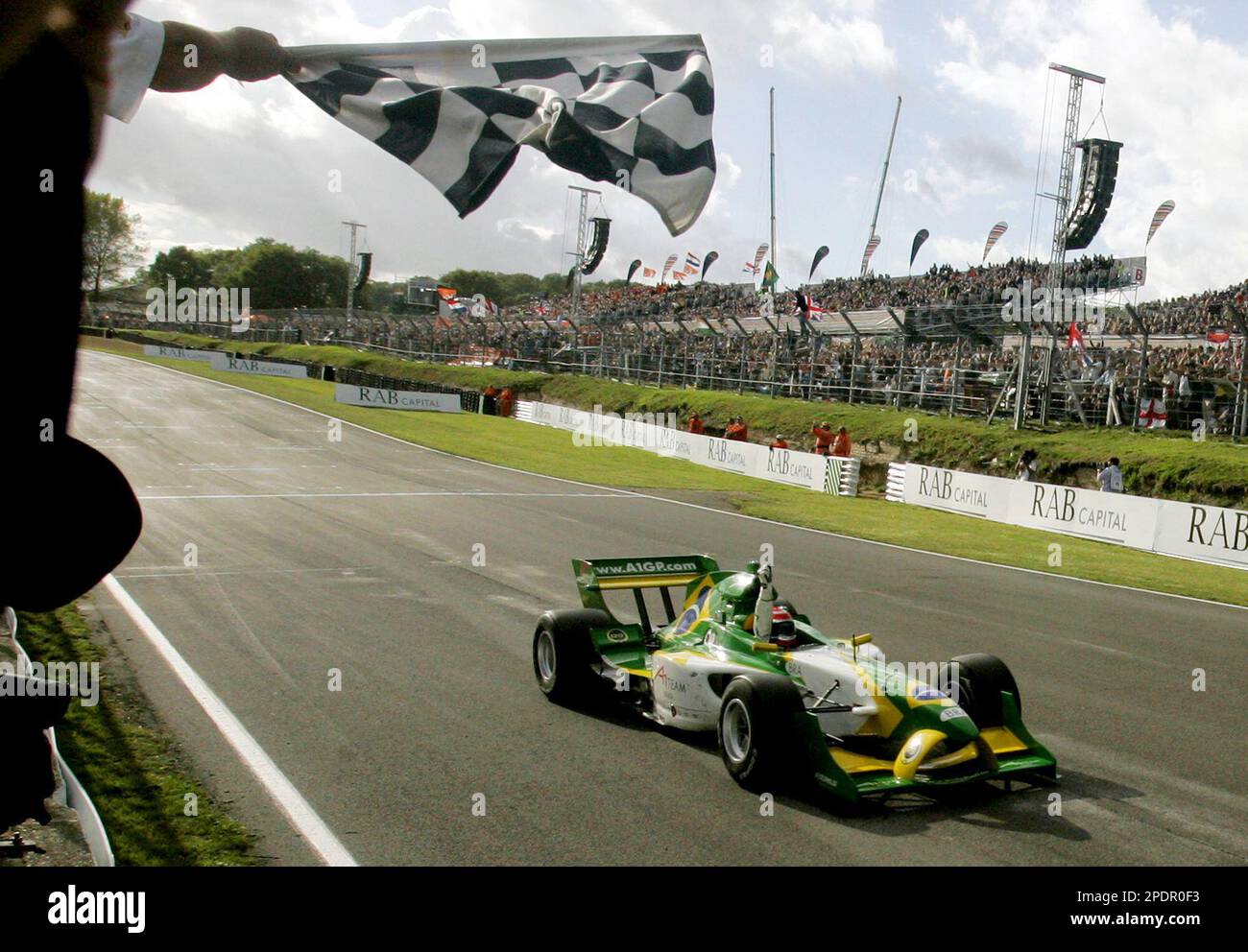 Brazil's Nelson Piquet Jnr holds up his arm in celebration as he ...