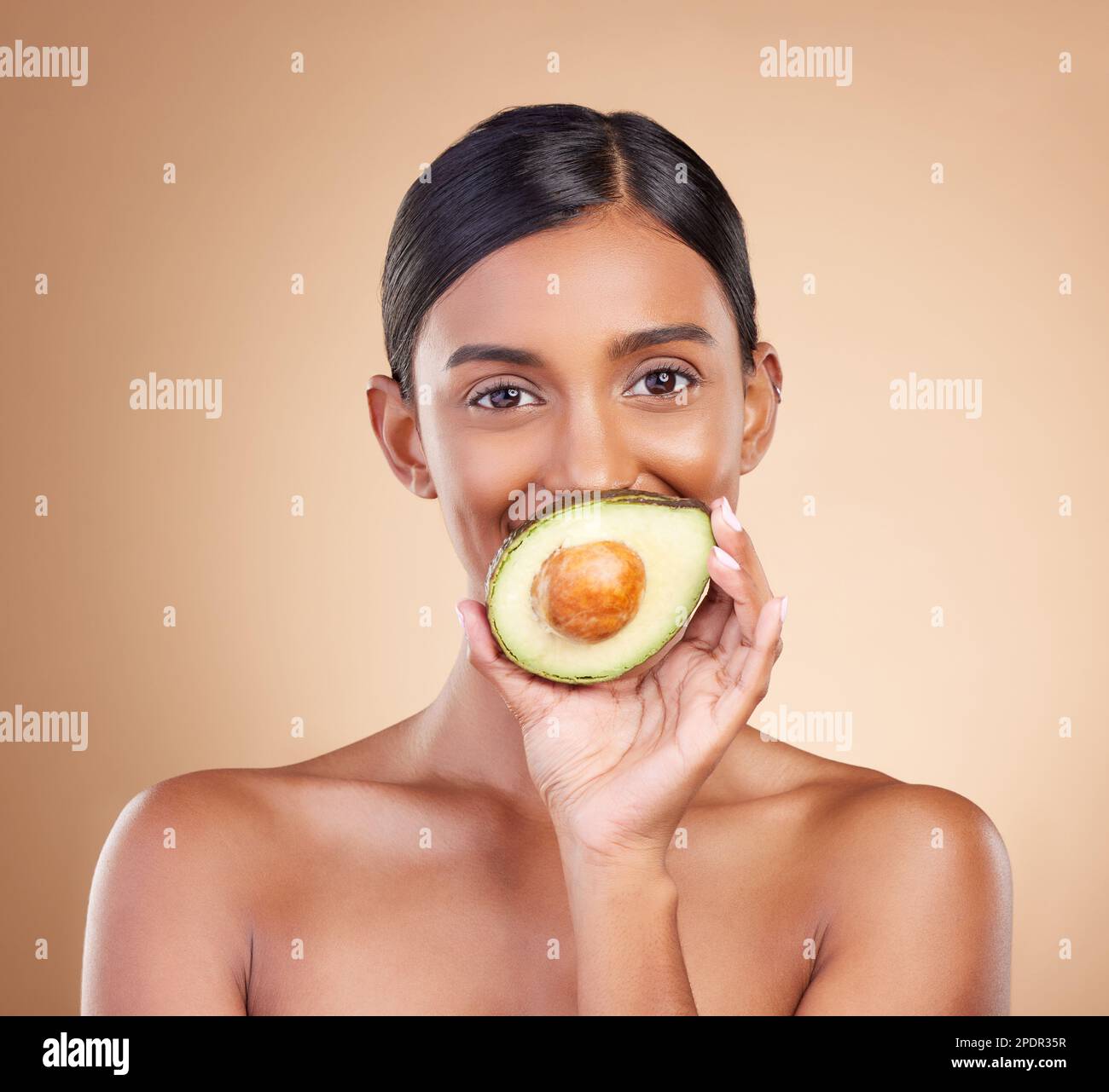 Portrait, skin or avocado with a model woman in studio on a beige ...
