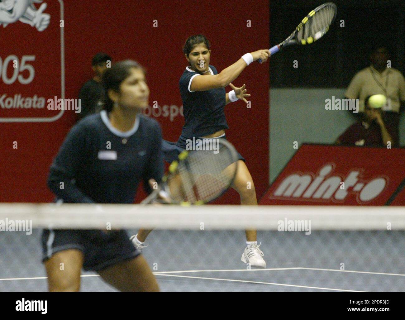 Neha Uberoi of United States, right, returns a serve as her sister ...