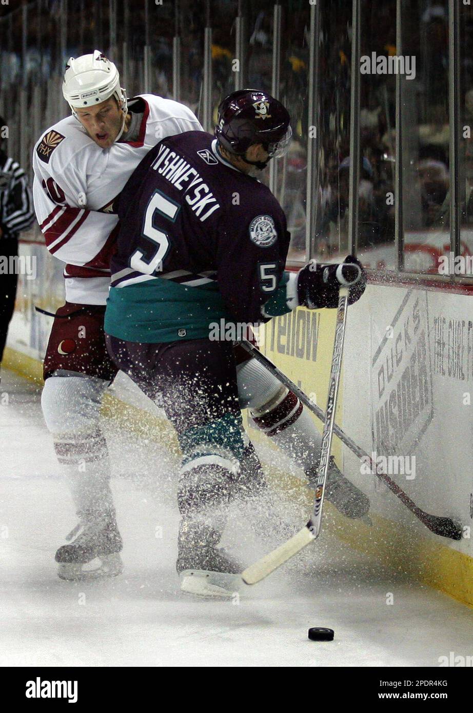 Phoenix Coyotes' Fredrik Sjostrom, left, is checked into the boards by ...